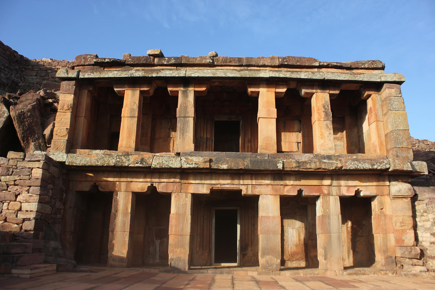 The two- storied jain temple and cave on hill under Meguti ...